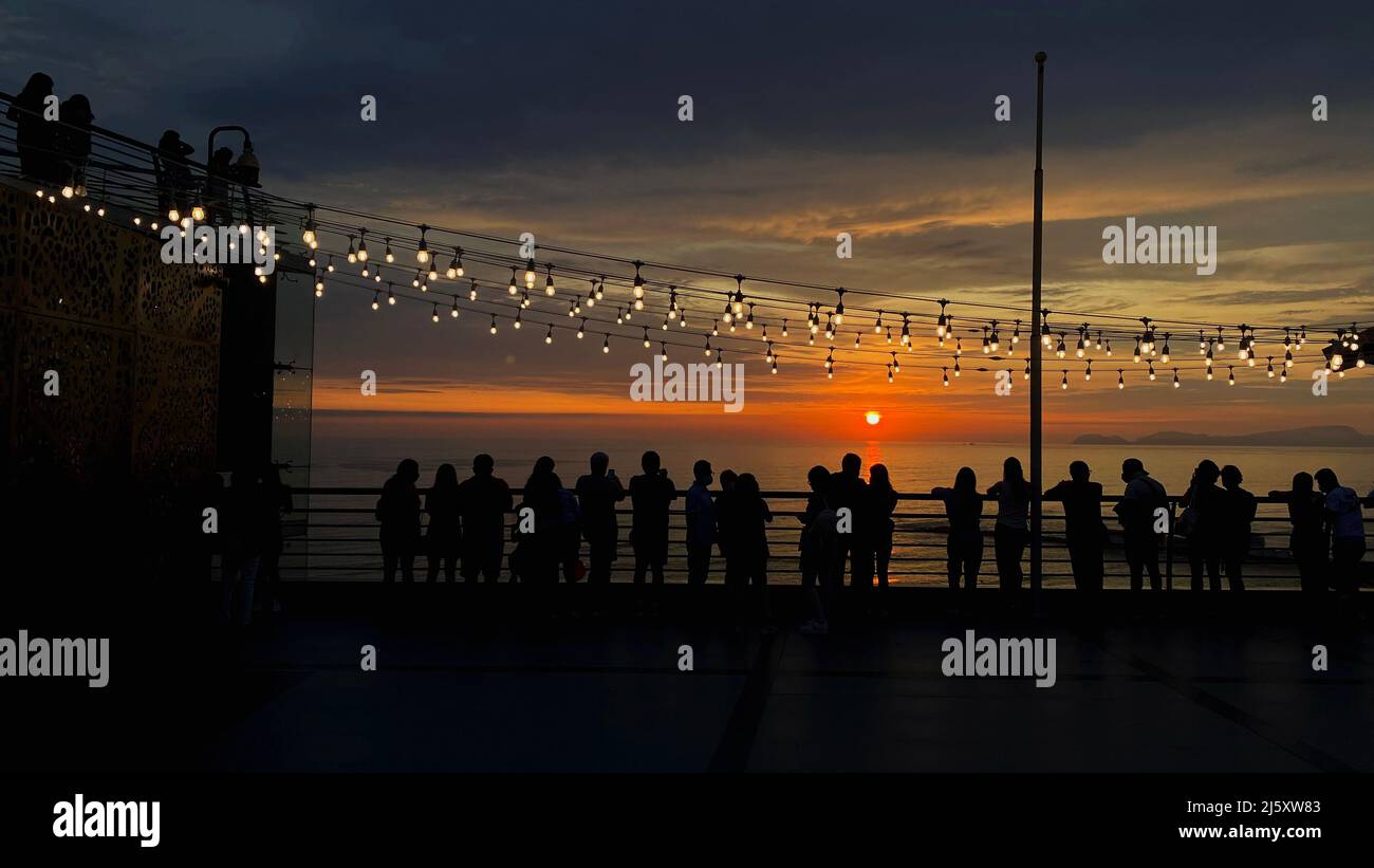 Silhouette of people at a panoramic viewpoint and looking at a ...