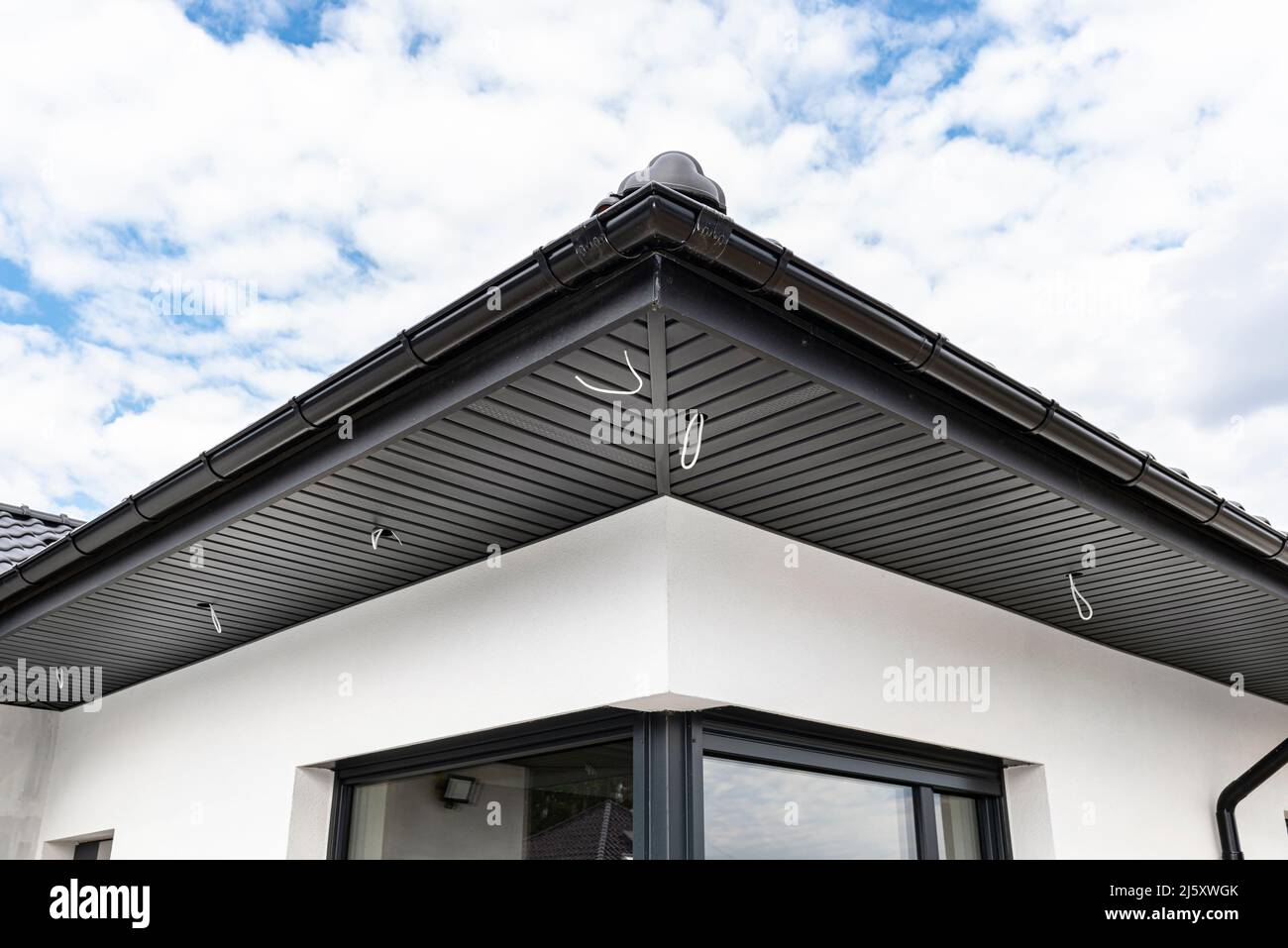 A modern graphite roof lining is attached to the trusses, visible ...
