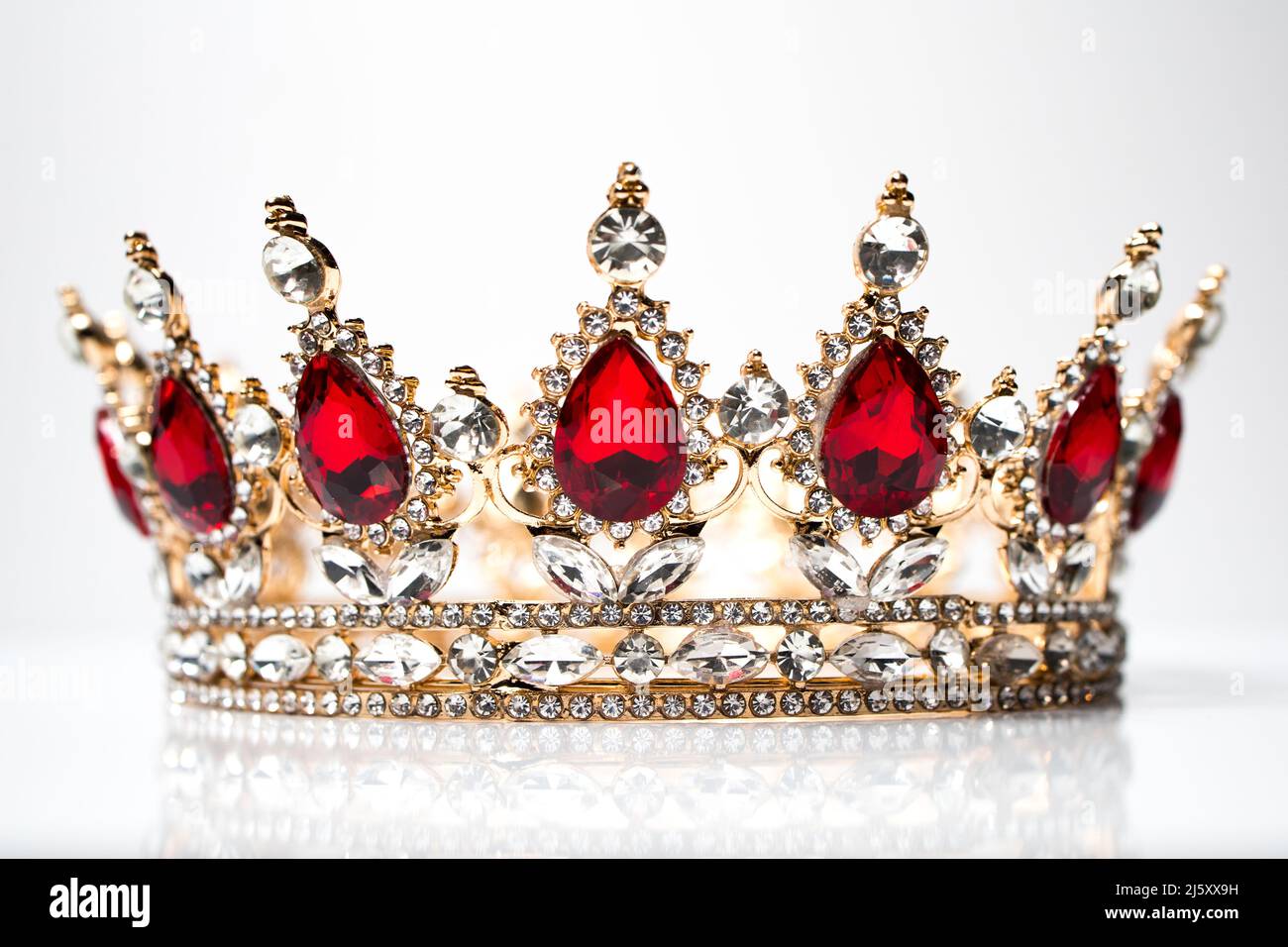 A golden crown replica decorated with red and white diamonds from the ...