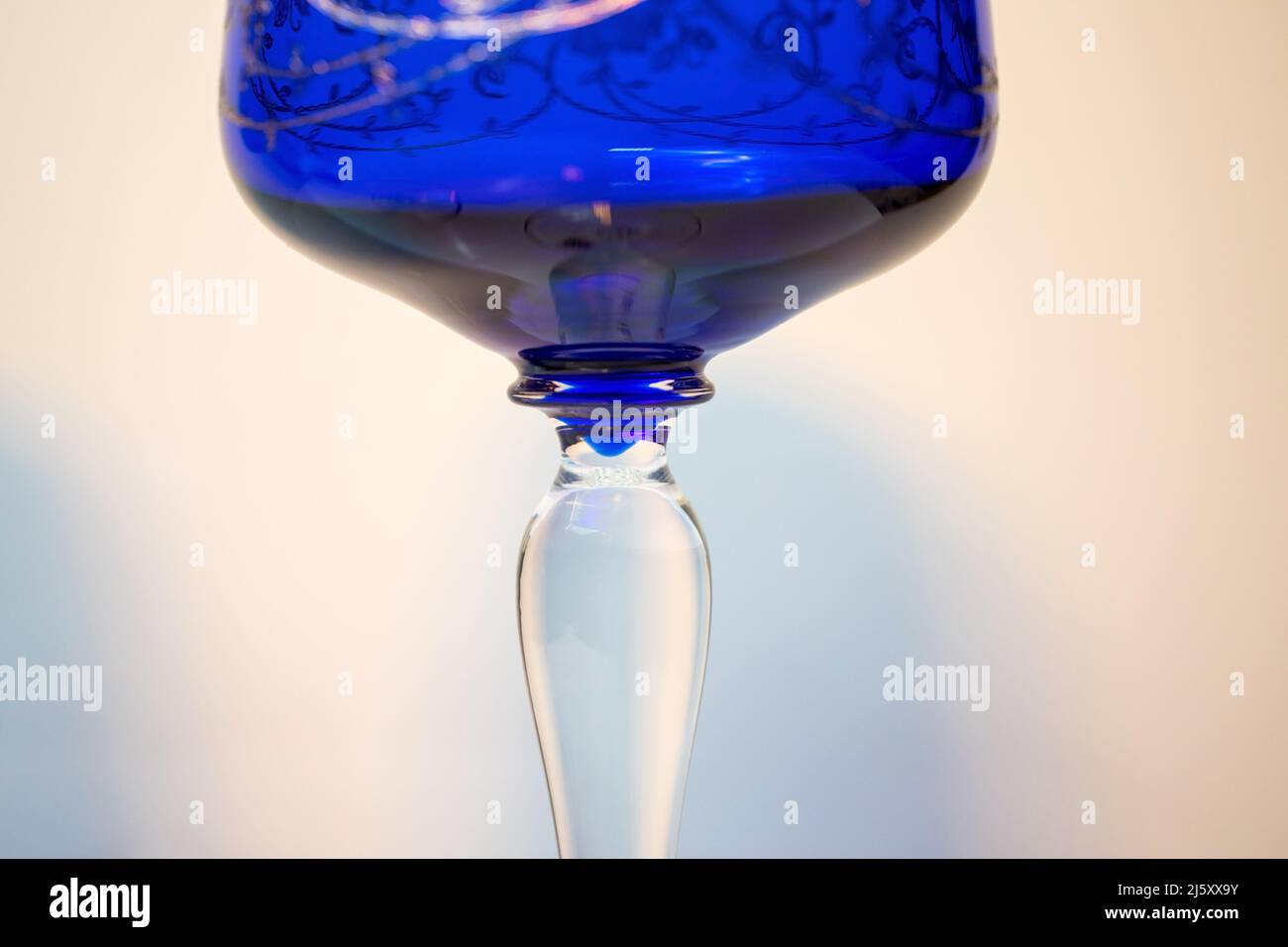 Closeup of the stem of a vintage bohemian crystal wine glass in color ...