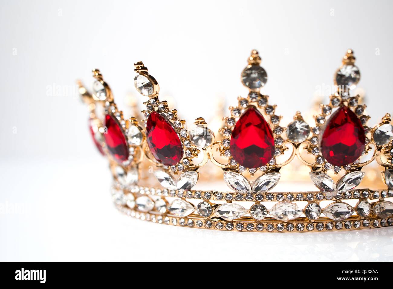 Closeup of a replica of a golden crown decorated with red and white ...
