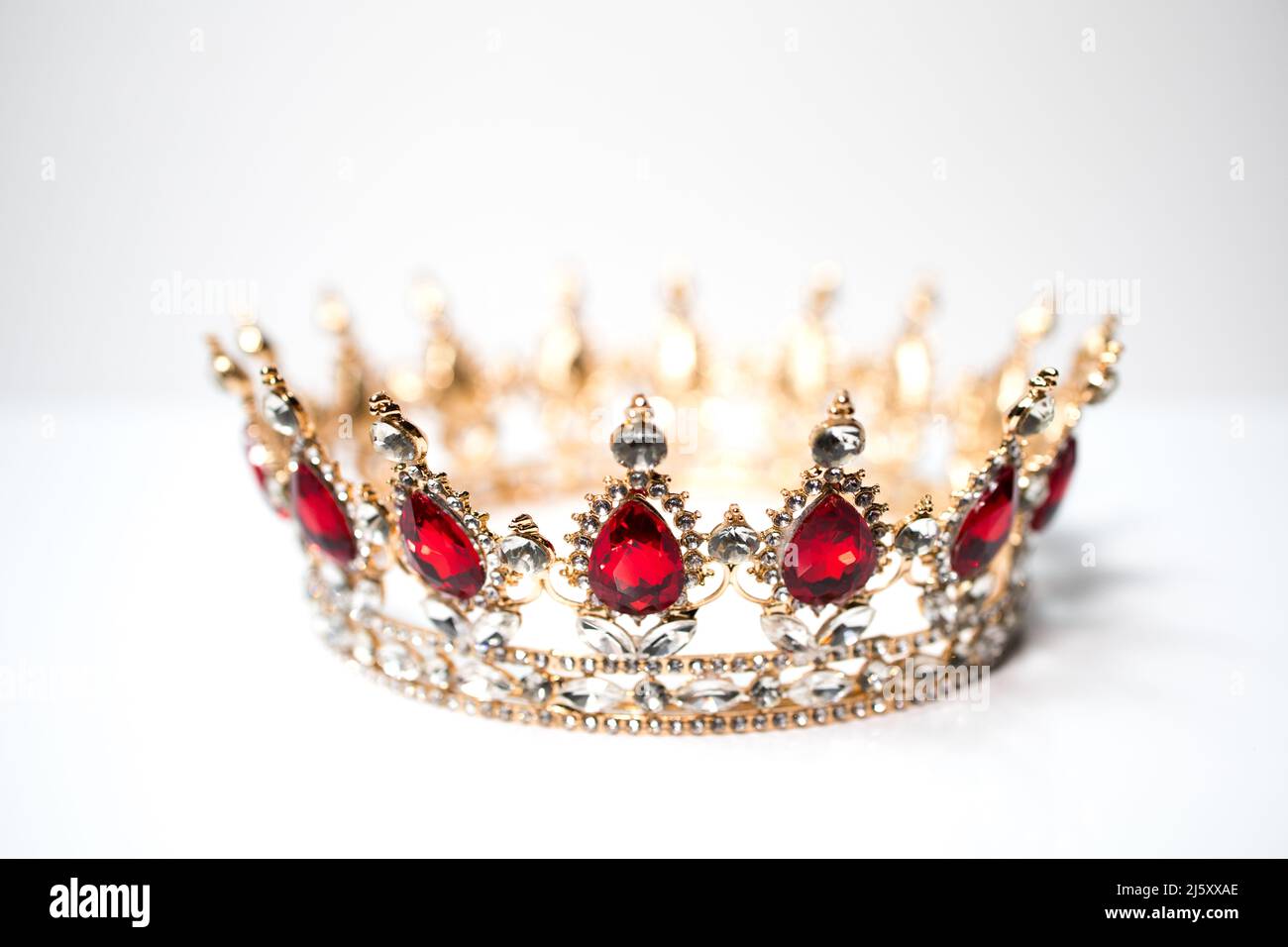 A replica of a golden crown decorated with red and white diamonds ...