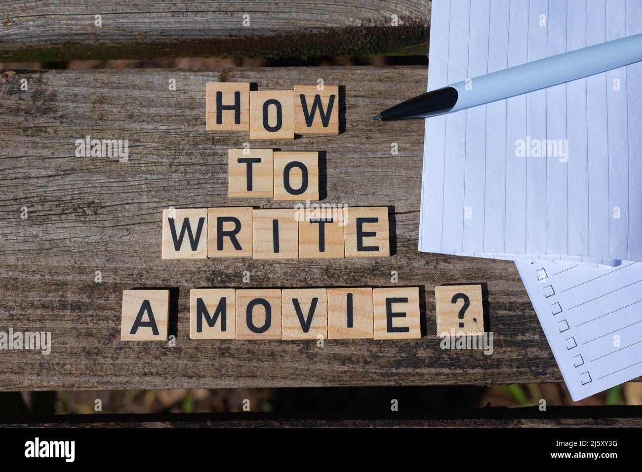 How to write a movie? Black capital letter words on wooden toy blocks ...