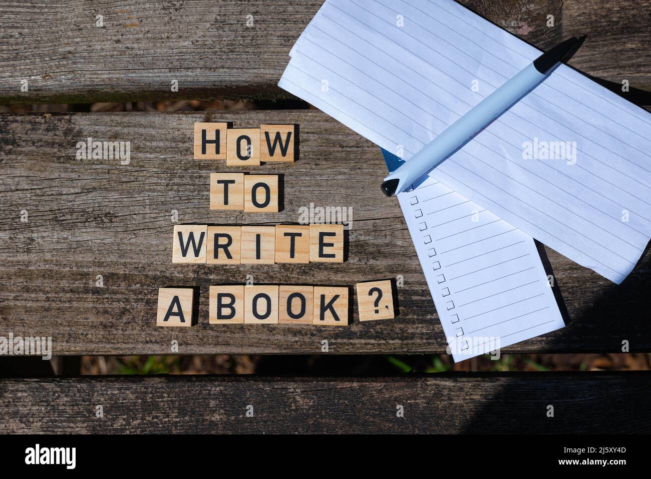 How to write a book? Black capital letter words on wooden toy blocks on ...
