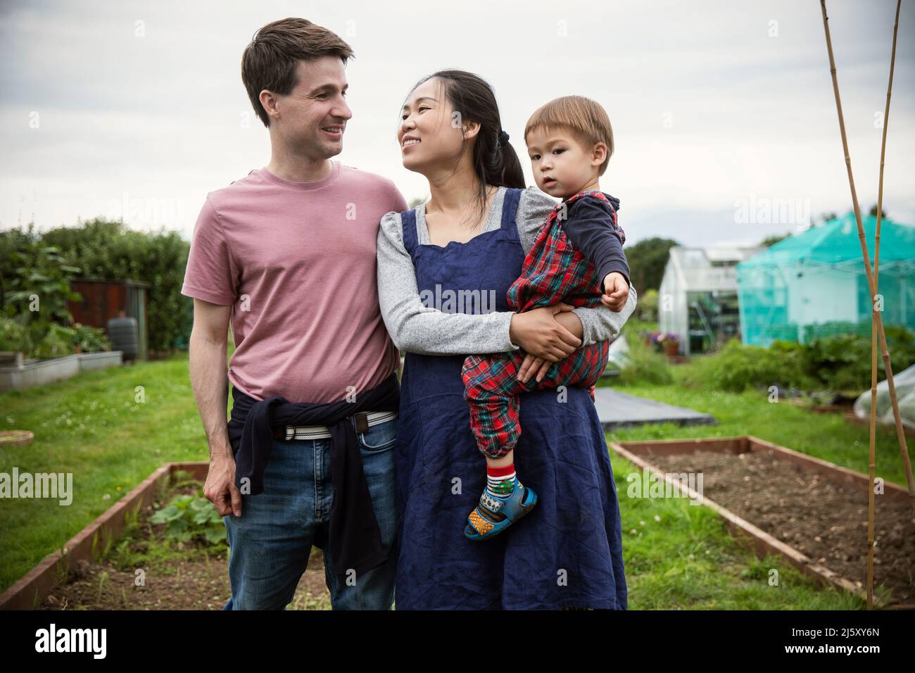 Happy family in backyard garden Stock Photo - Alamy