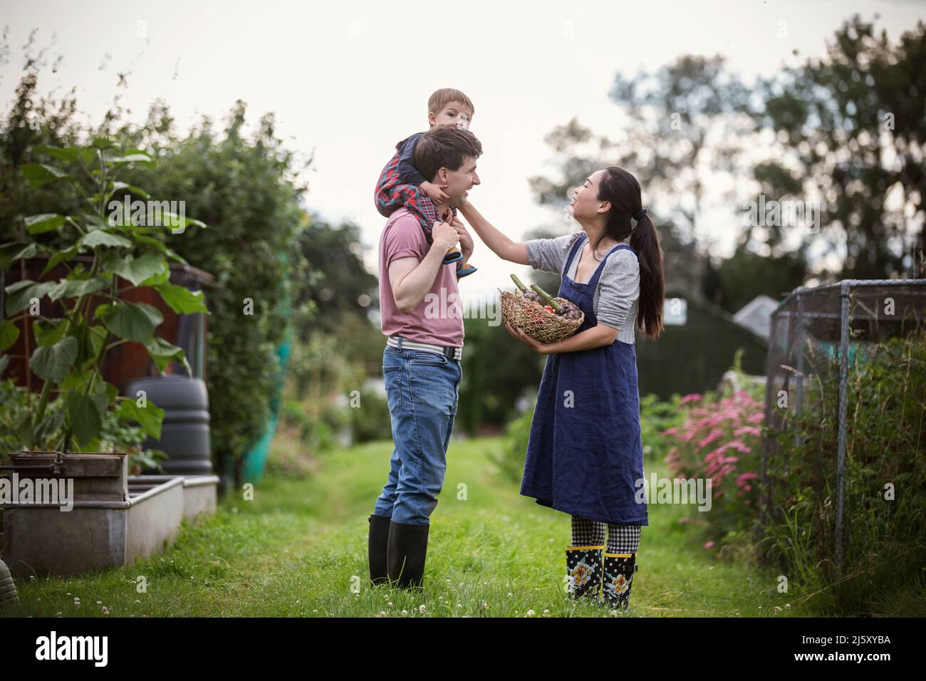 Happy family in backyard garden Stock Photo - Alamy