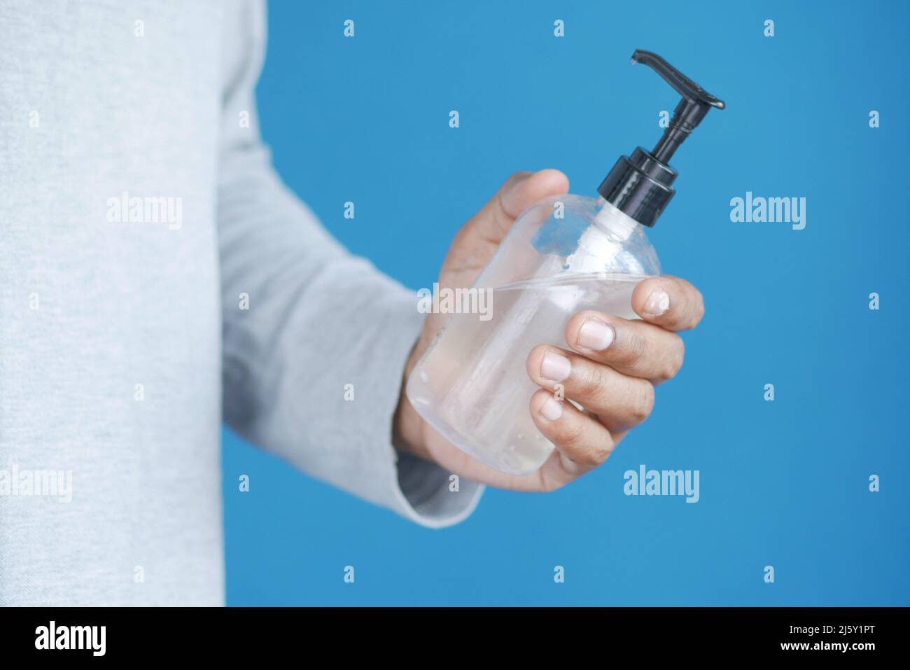 Using sanitizer liquid for preventing corona virus Stock Photo - Alamy