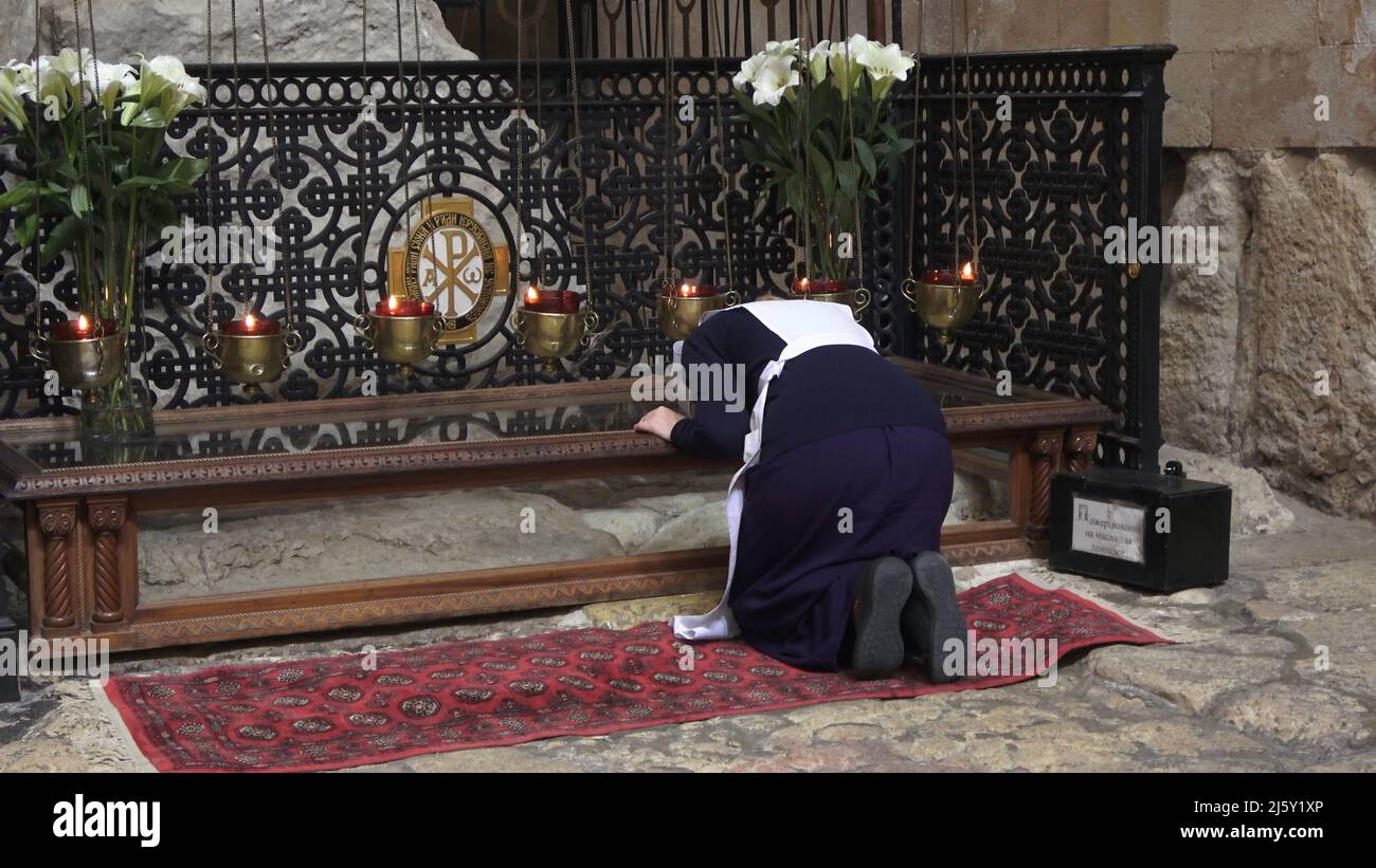 A Russian Orthodox nun prays over remains of the “Judgement Gate ...