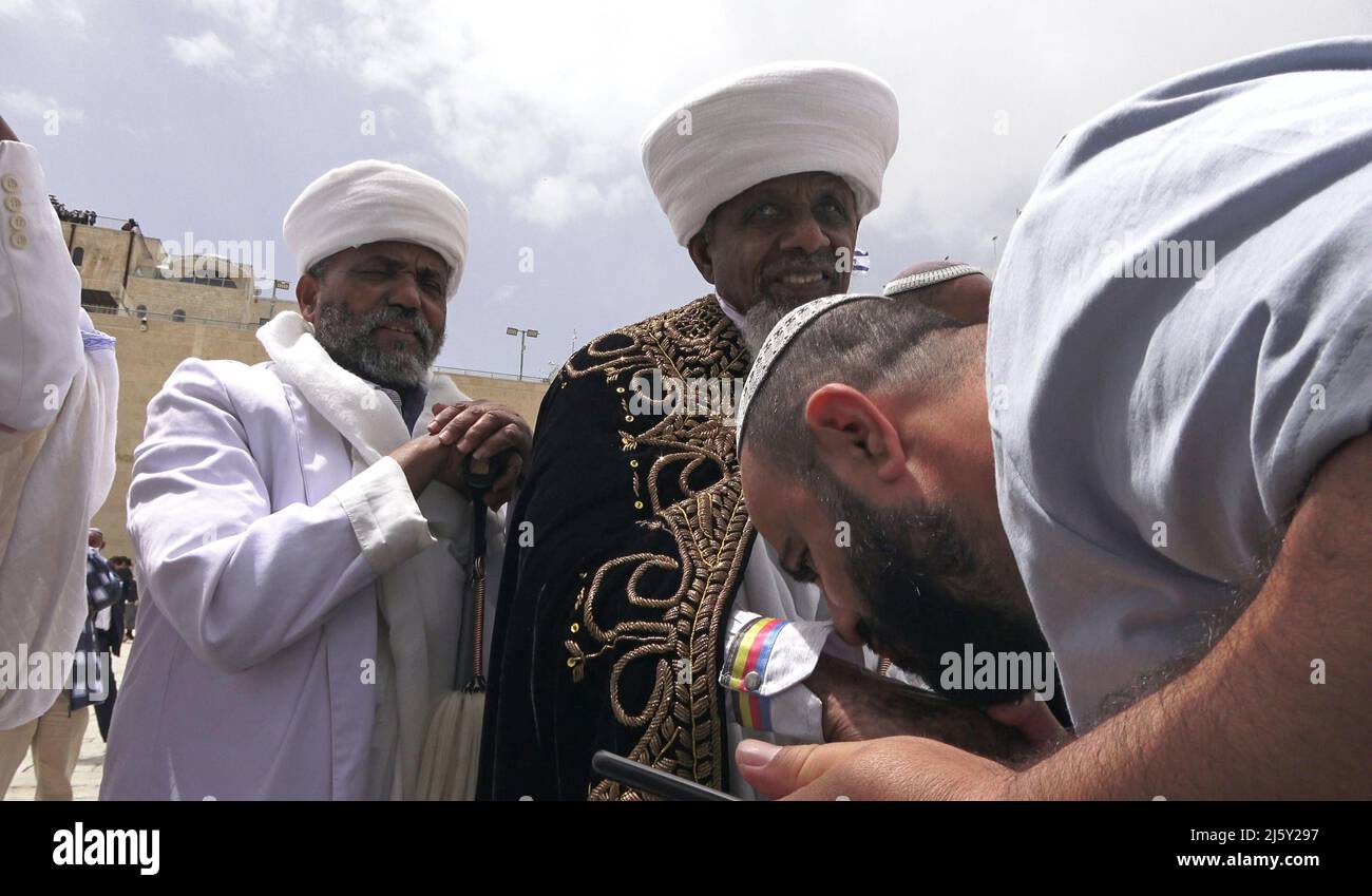 A religious Israeli man kisses the hand of a white turbaned religious ...