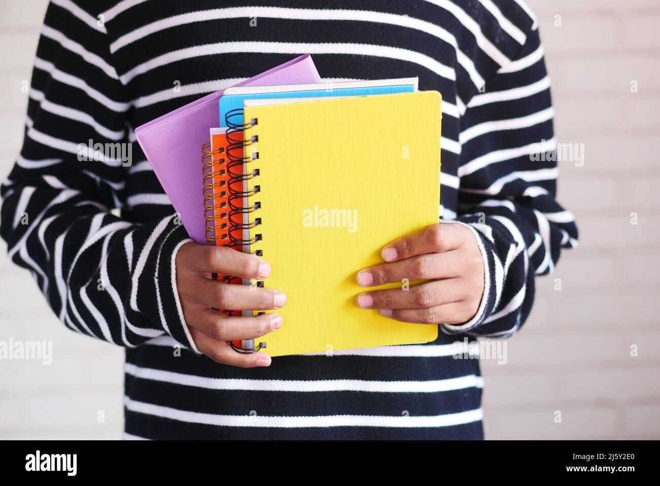 teenage boy holing colorful notepad Stock Photo - Alamy