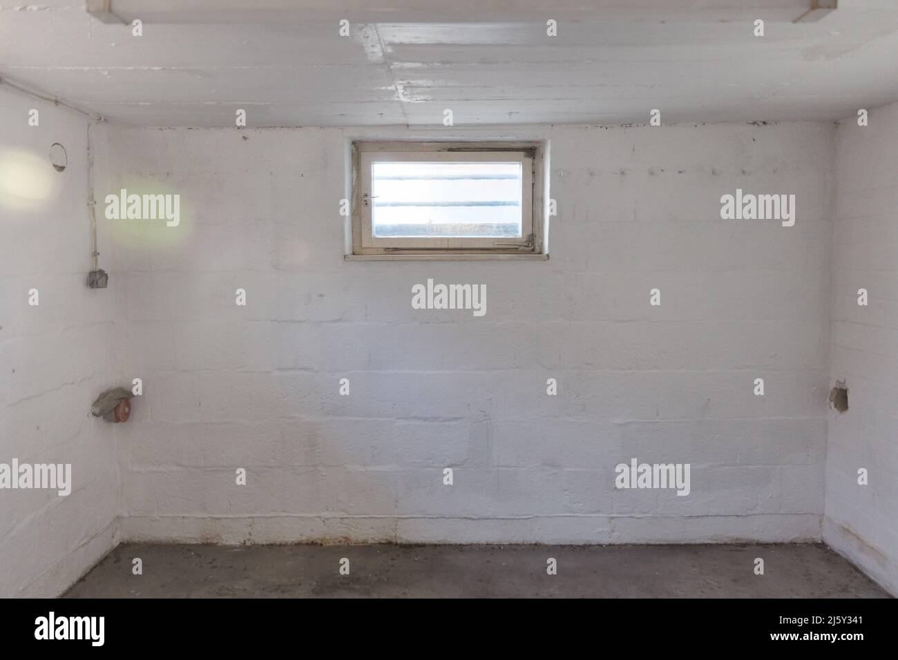 Empty room in the basement with a basement window as a drying room or ...
