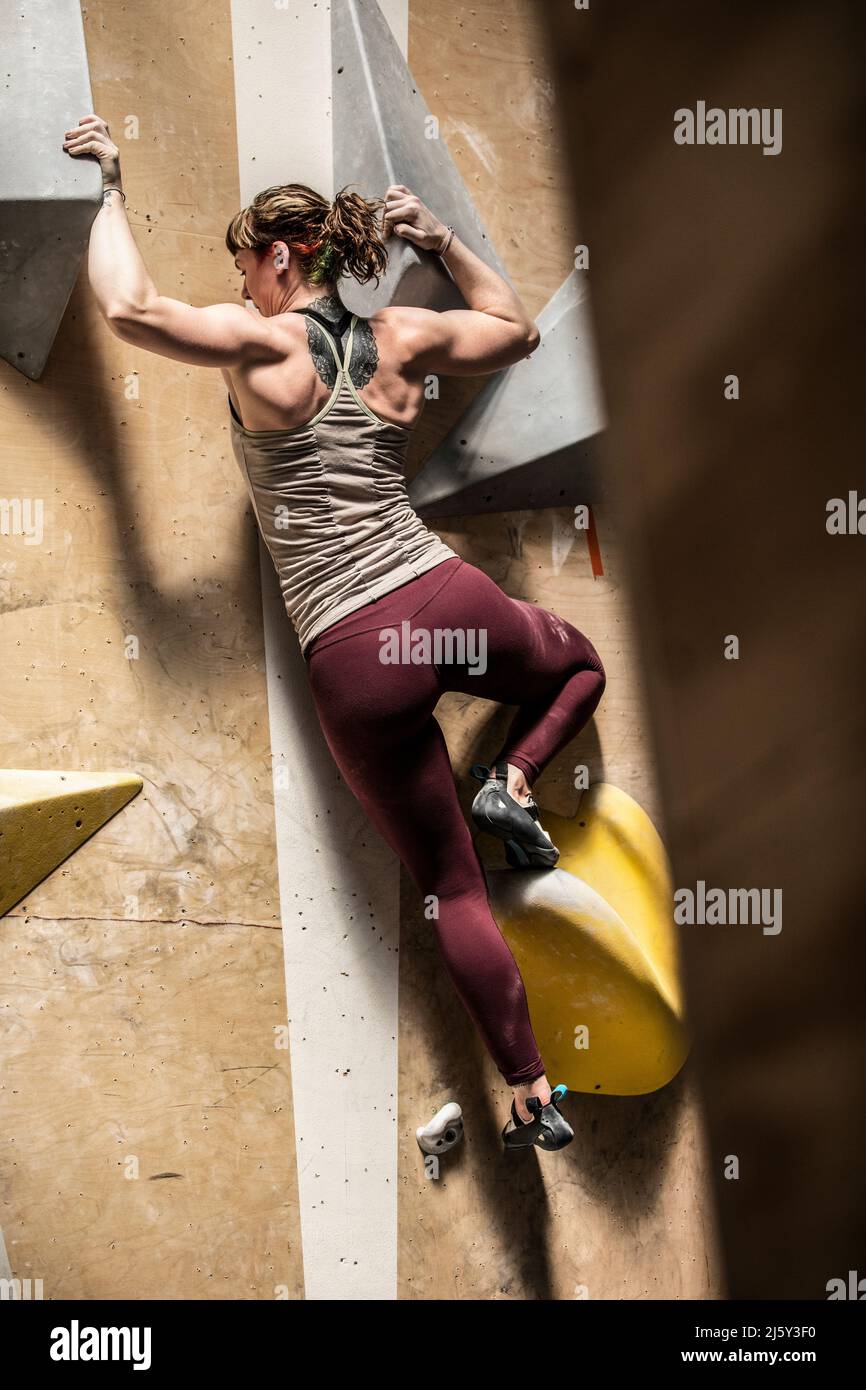 Athletic woman on climbing wall Stock Photo - Alamy