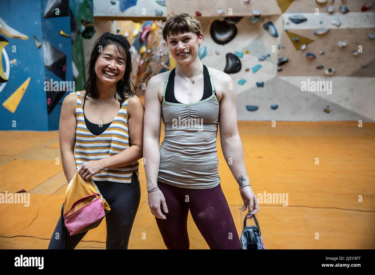 Portrait happy female rock climbers at climbing center Stock Photo - Alamy