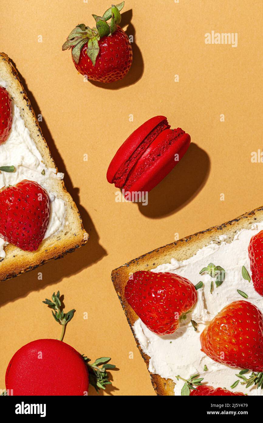Top view of tasty toasts with cream cheese and ripe strawberries ...