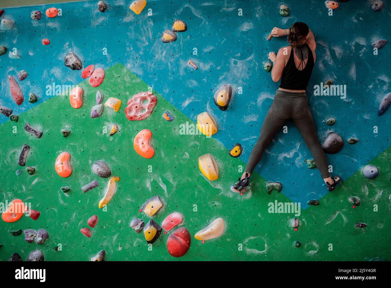 Female rock climber training on climbing wall Stock Photo - Alamy