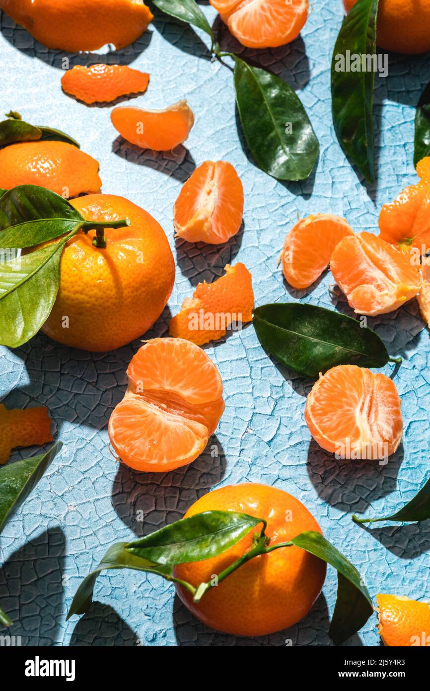 Top view full frame background of ripe tropical tangerines with leaves ...
