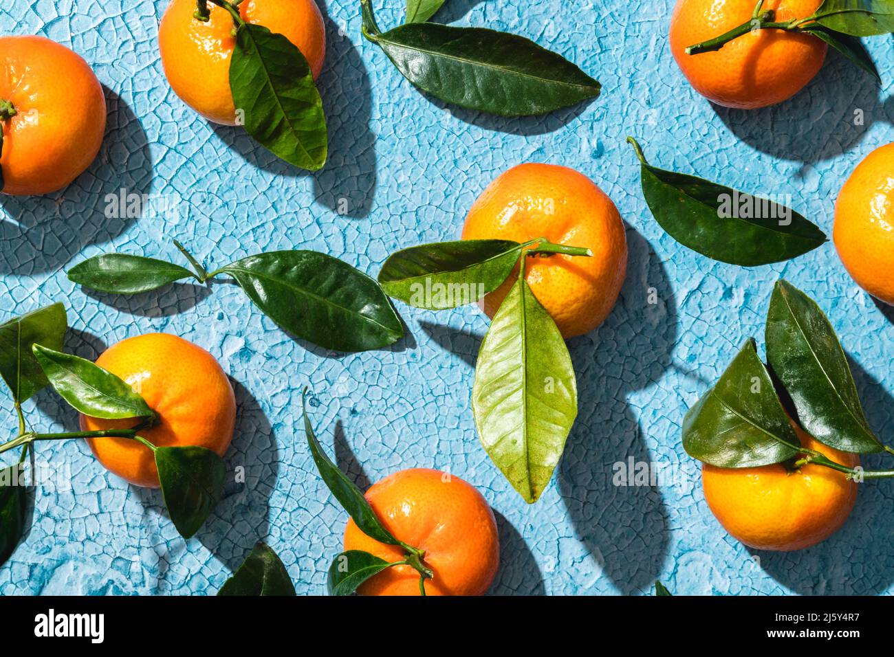 Top view full frame background of ripe tropical tangerines with leaves ...