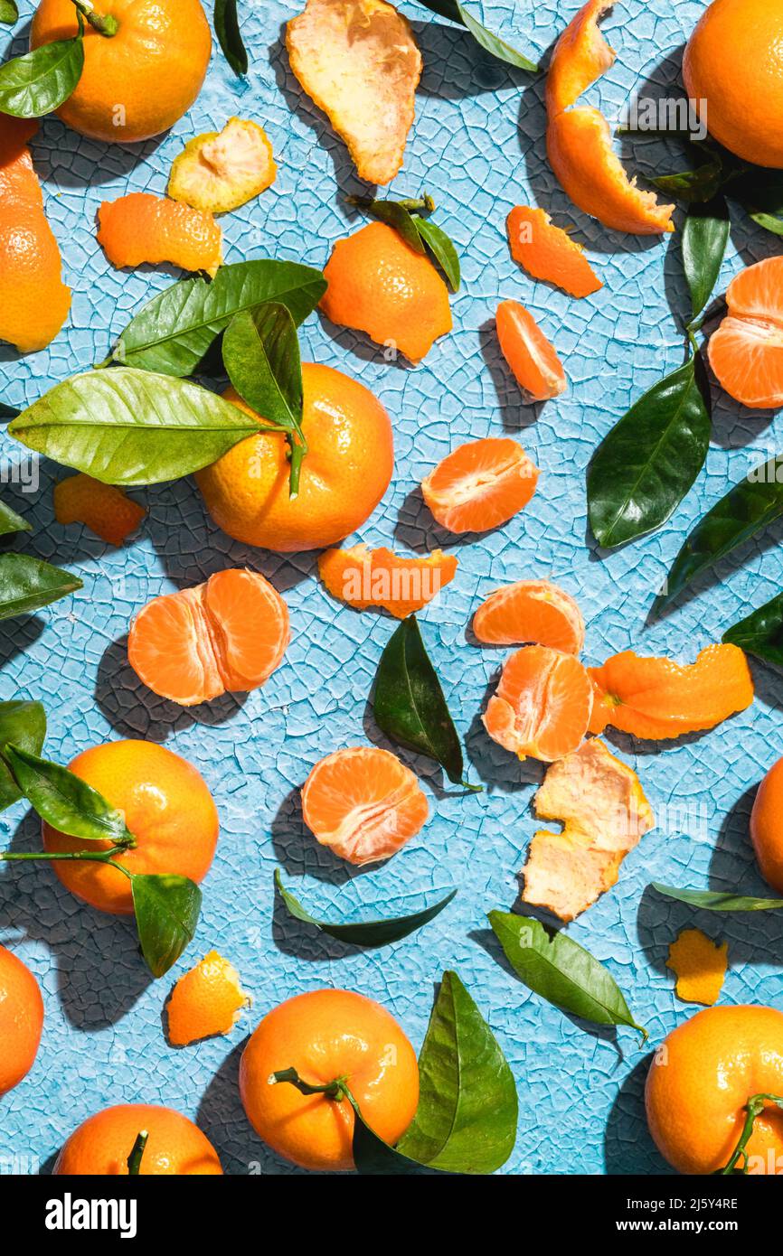 Top view full frame background of ripe tropical tangerines with leaves ...