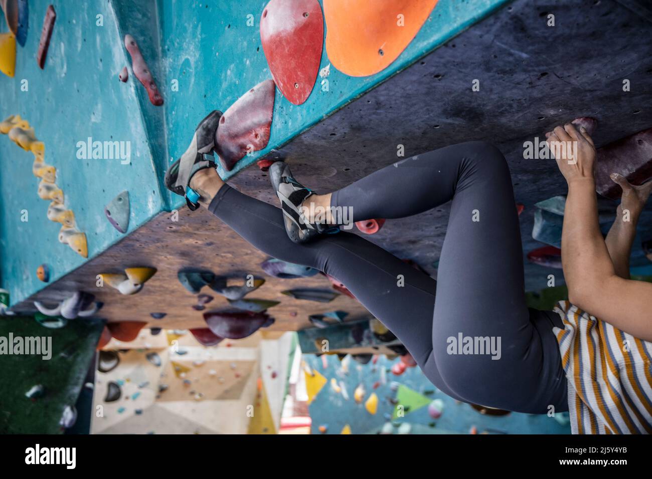 Legs of female rock climber on climbing wall Stock Photo - Alamy