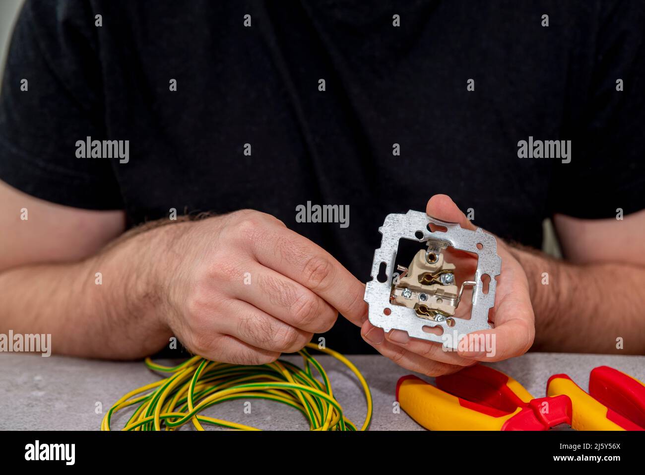 electrician repairing a faulty socket in his workshop Stock Photo - Alamy