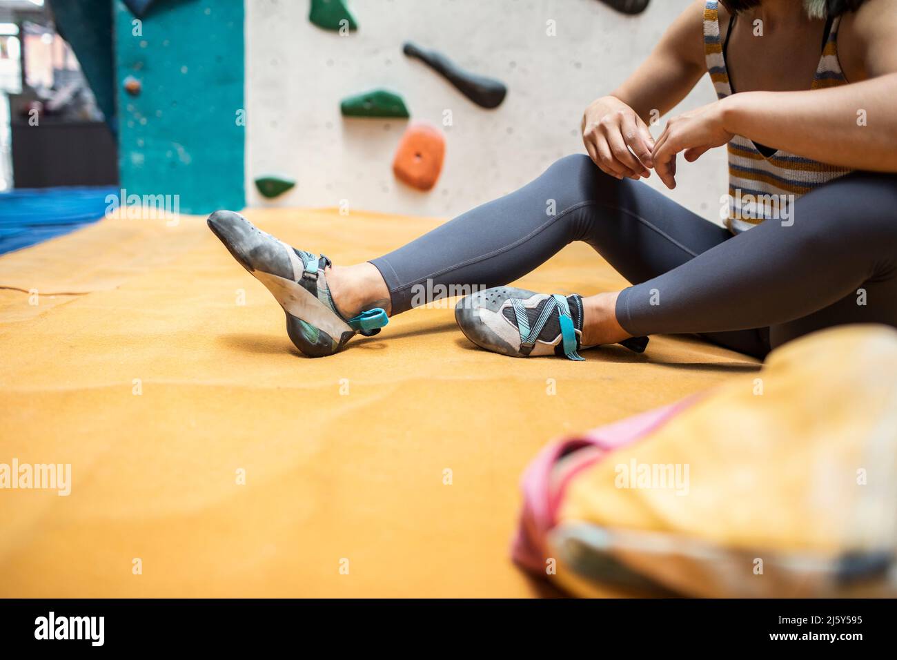 Female rock climber resting on mat in climbing gym Stock Photo - Alamy