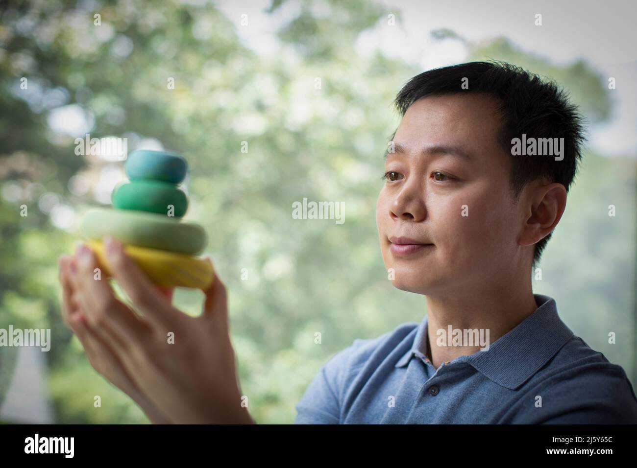 Close up man holding stacked wood blocks Stock Photo - Alamy