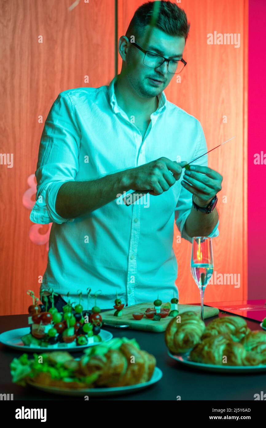Man preparing party snacks hi-res stock photography and images - Alamy