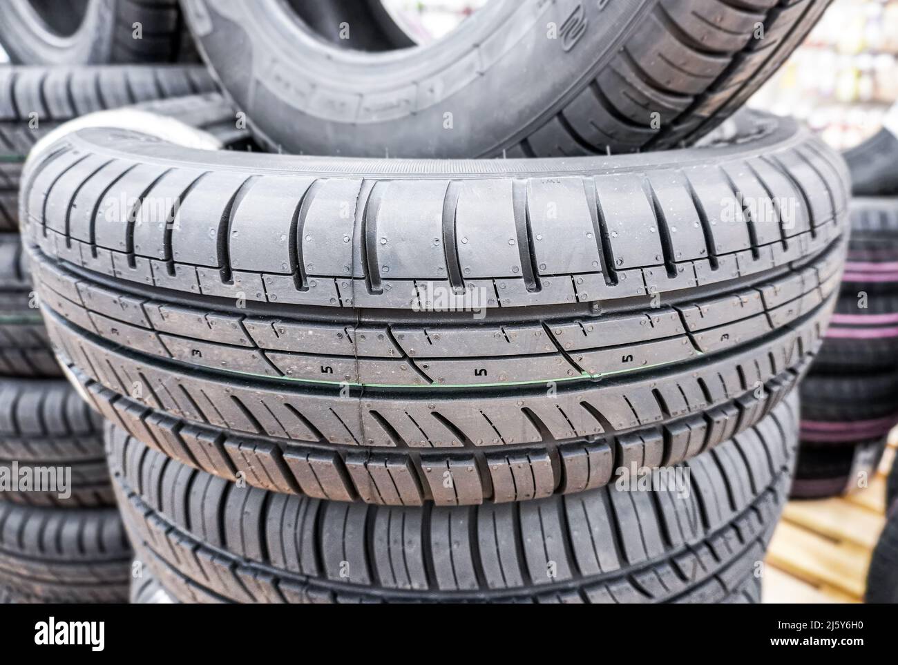 New summer tyres stacked up for sale in a superstore Stock Photo - Alamy