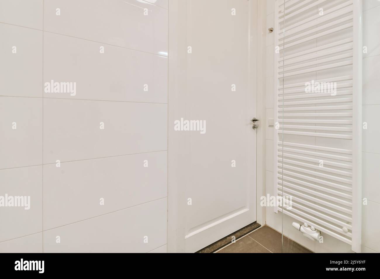 Glass shower cabin near radiator in light bathroom in apartment Stock ...