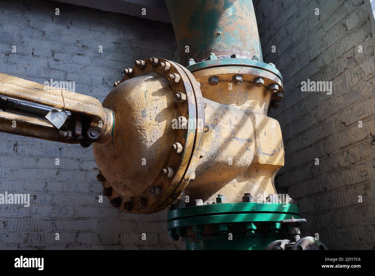 Close-up at pipeline valve which is using to control production process ...