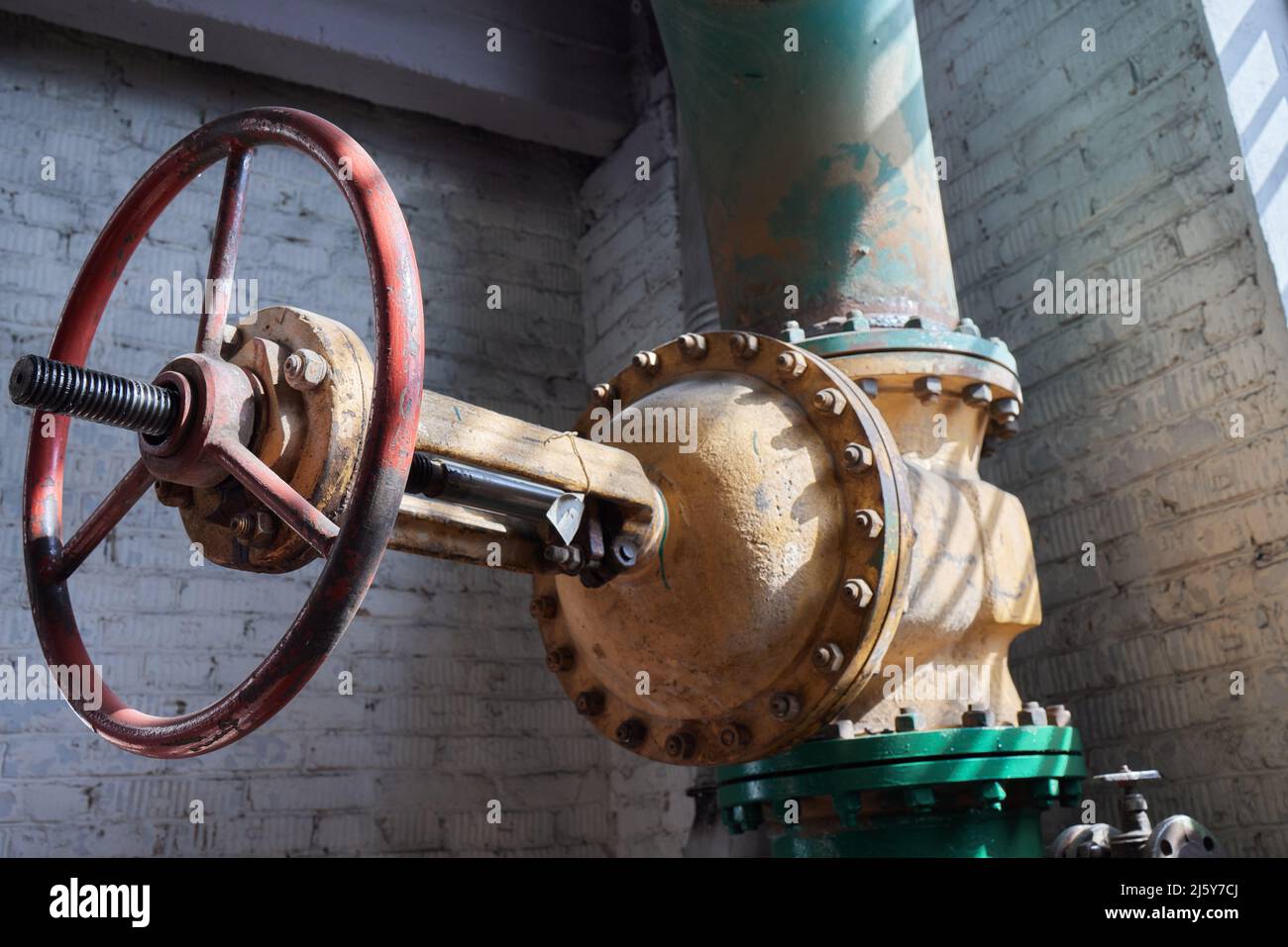 Close-up at pipeline valve which is using to control production process ...