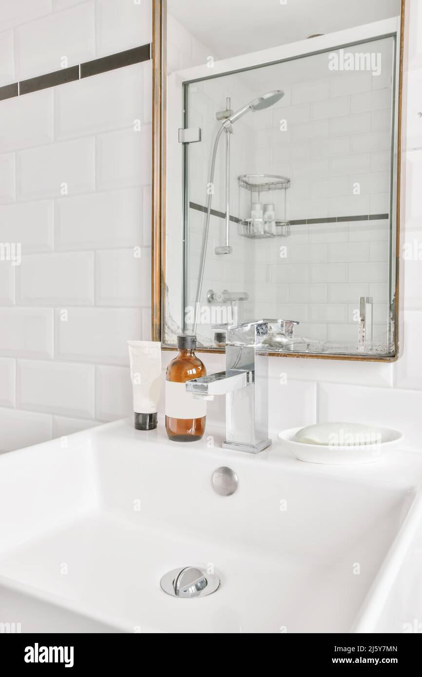 Close-up of a washbasin with soap dish and above it a mirror with the ...