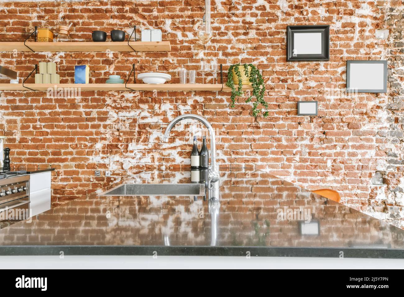 Side view of a black mirrored countertop and sink and in the background ...
