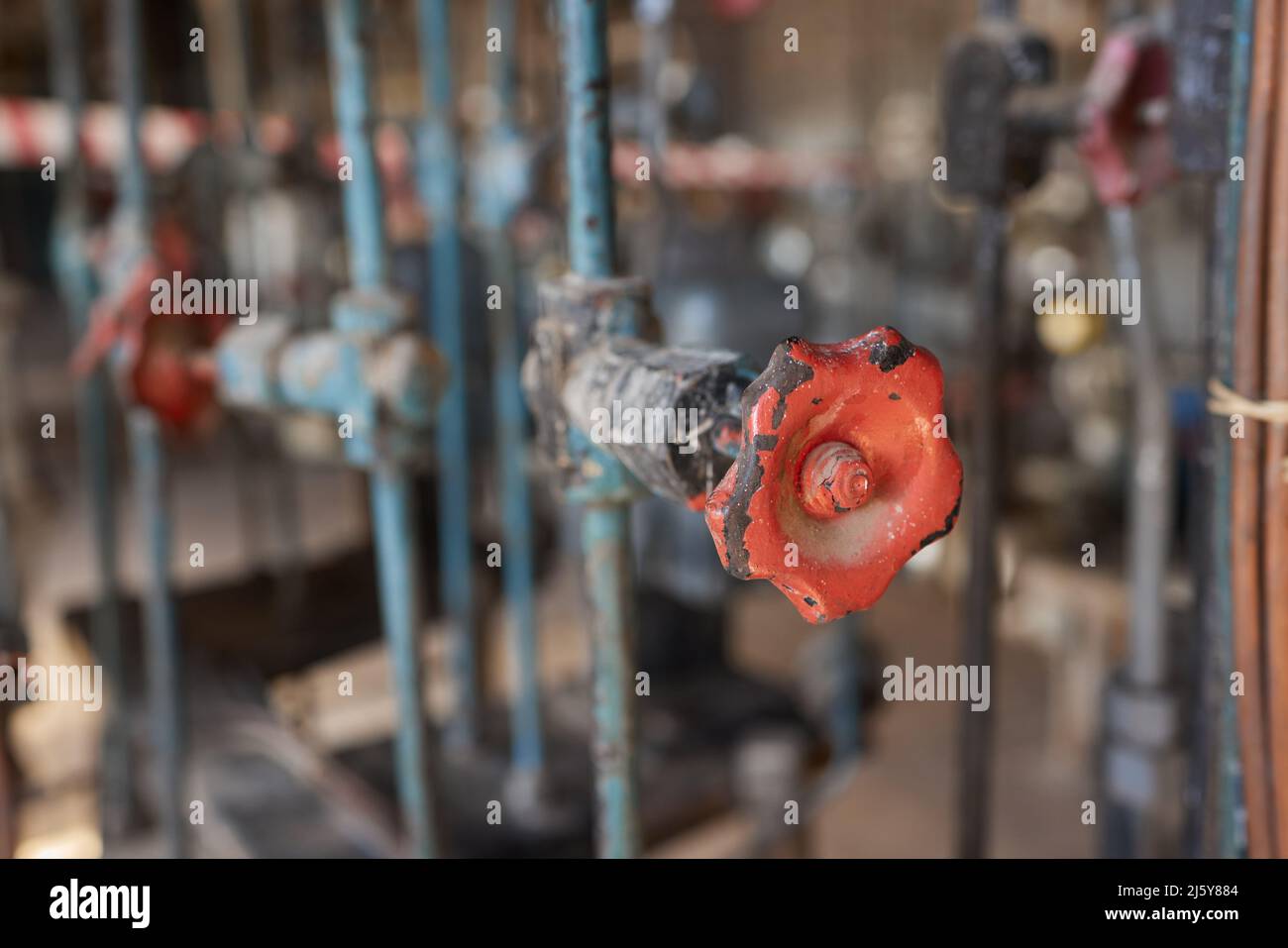 Close-up at pipeline valve which is using to control production process ...