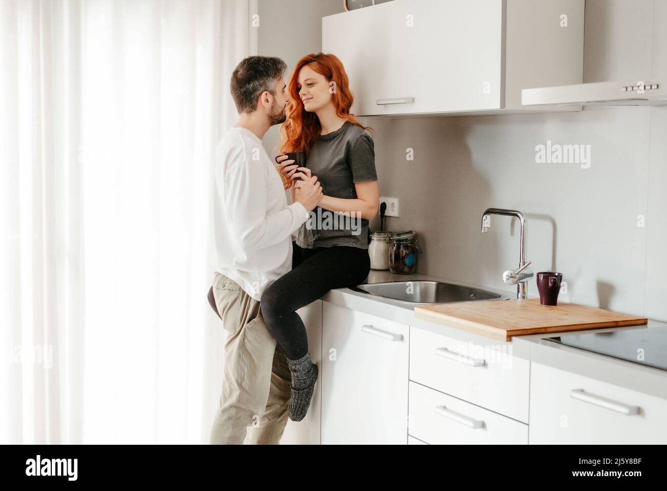Couple cuddle coffee hi-res stock photography and images - Alamy