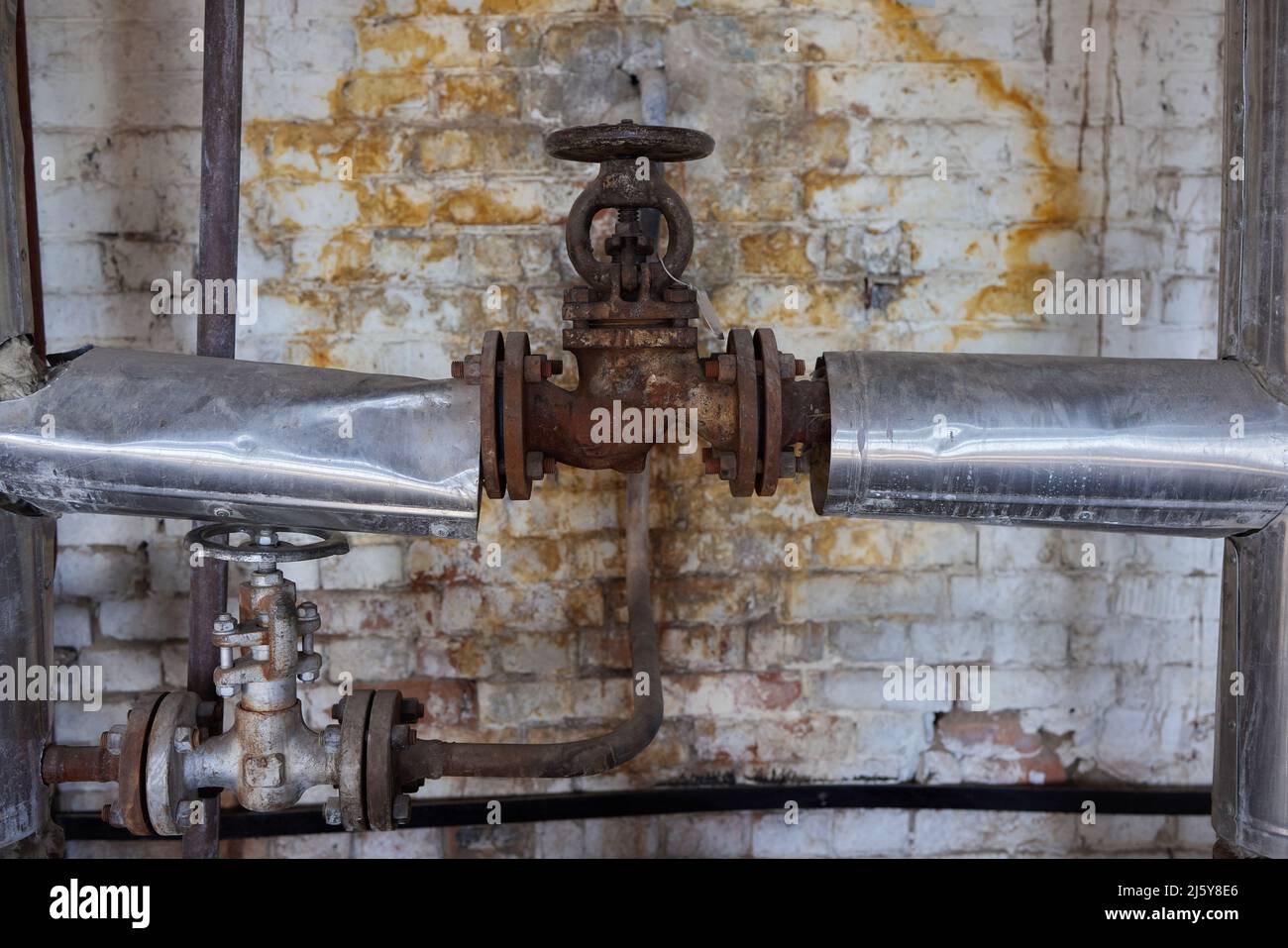 Close-up at pipeline valve which is using to control production process ...