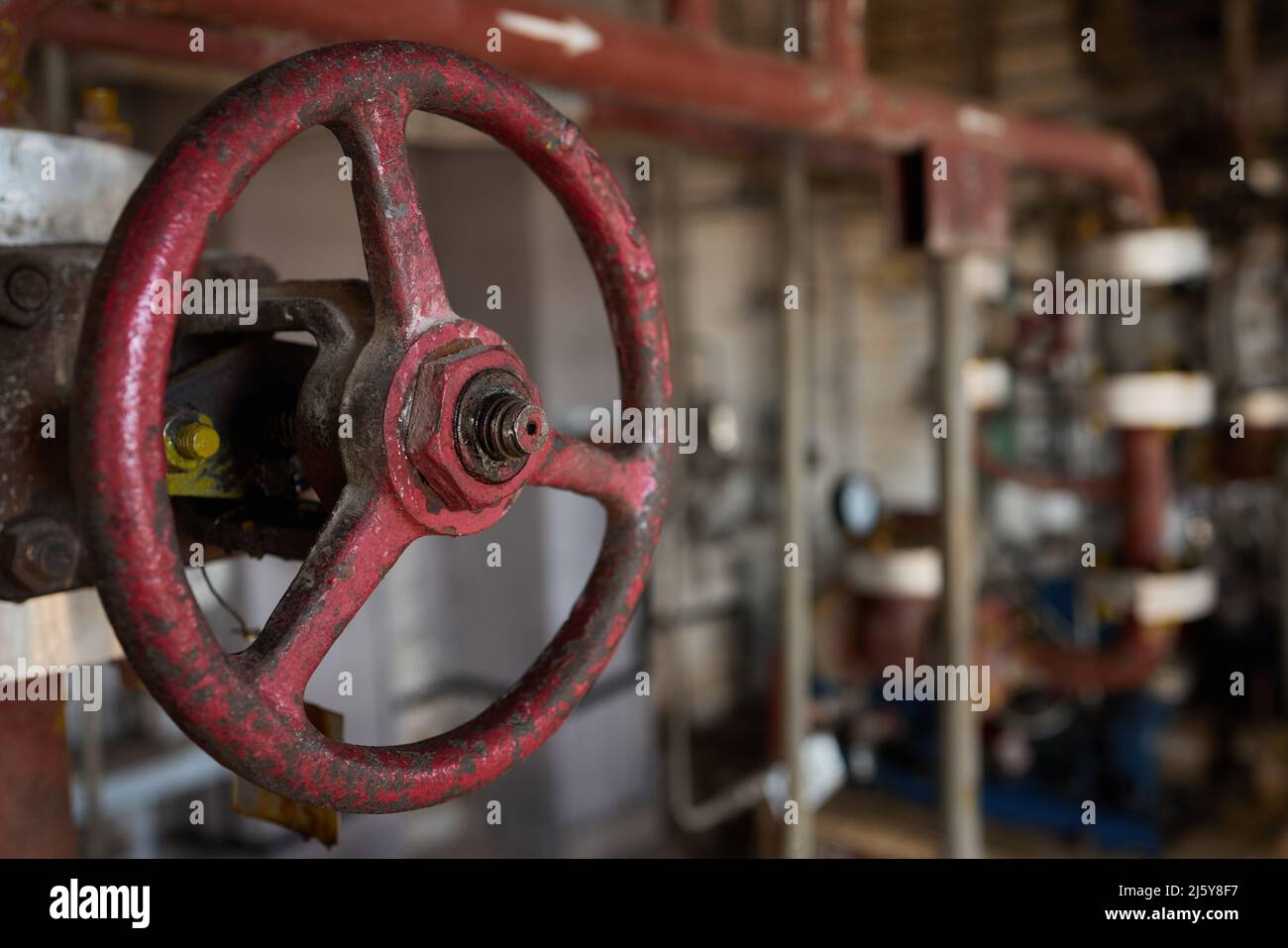 Close-up at pipeline valve which is using to control production process ...