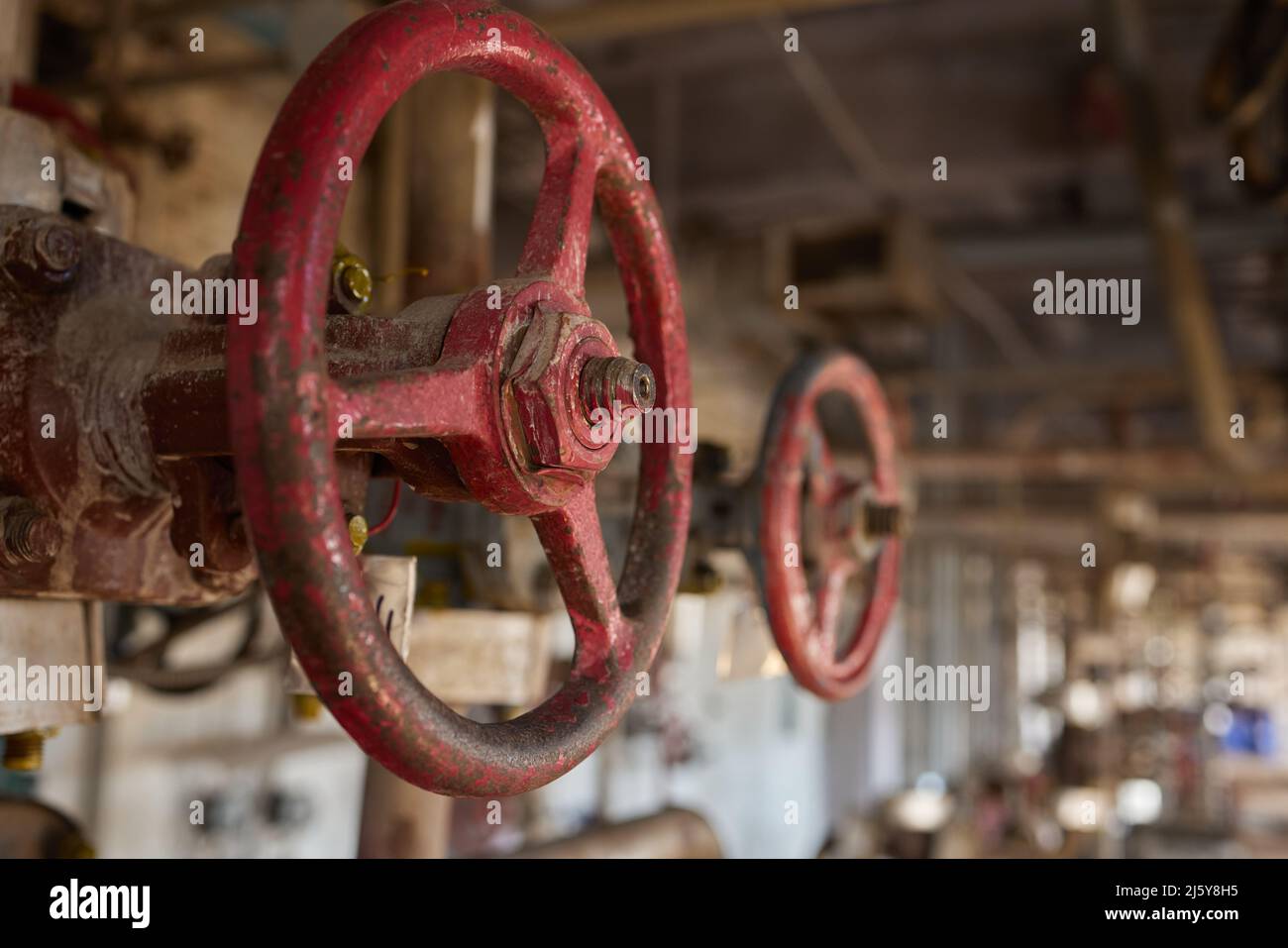 Close-up at pipeline valve which is using to control production process ...