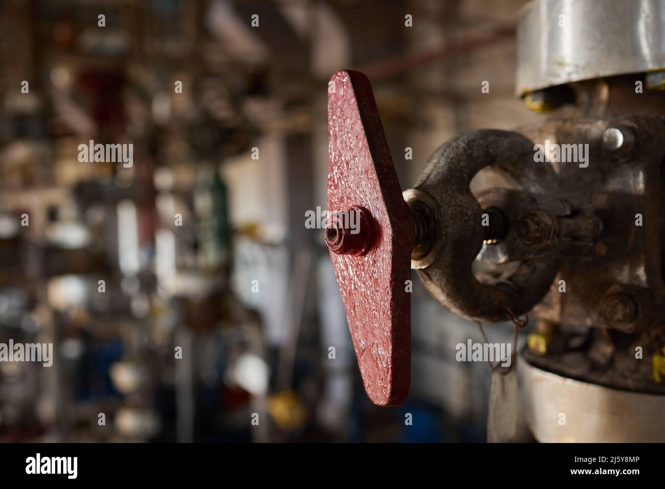 Close-up at pipeline valve which is using to control production process ...