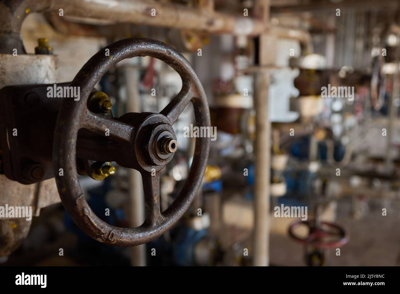 Close-up at pipeline valve which is using to control production process ...