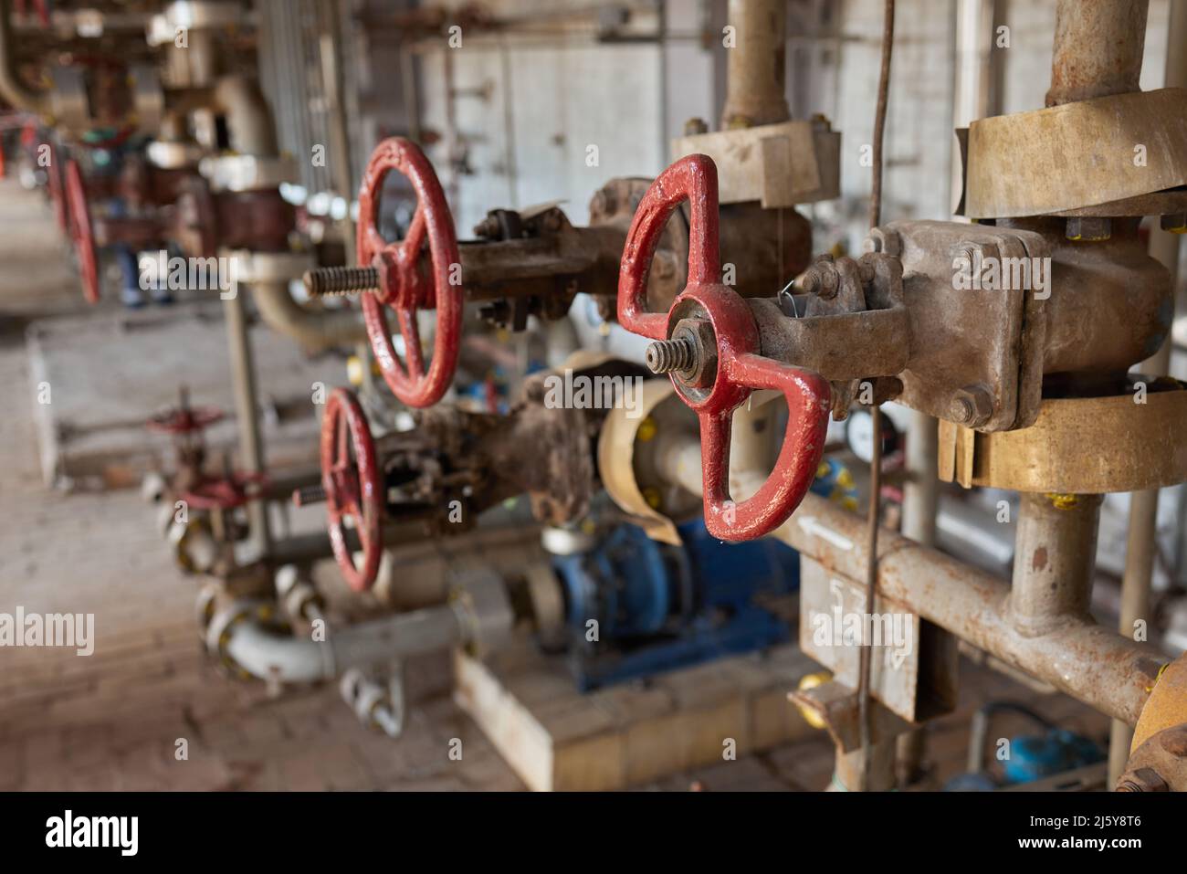 Close-up at pipeline valve which is using to control production process ...