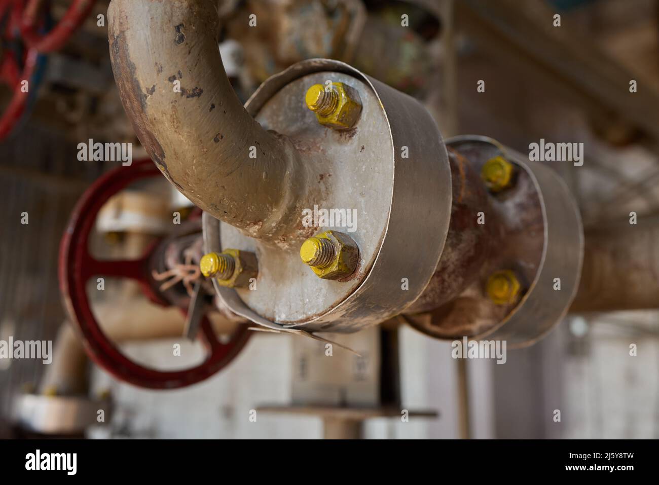Close-up at pipeline valve which is using to control production process ...