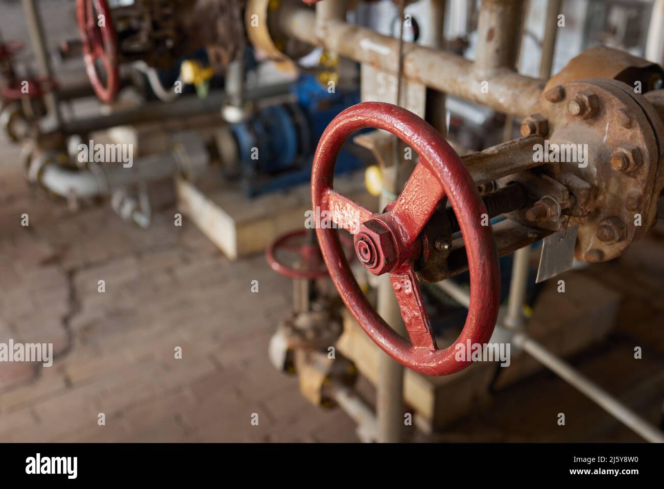 Close-up at pipeline valve which is using to control production process ...