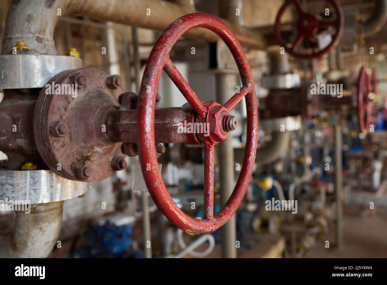 Close-up at pipeline valve which is using to control production process ...