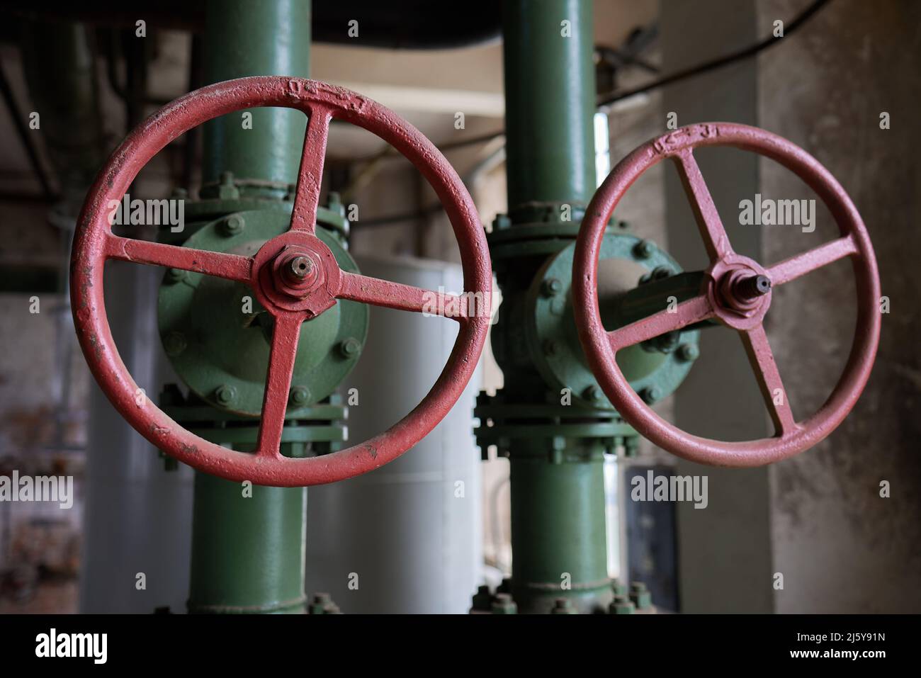 Close-up at pipeline valve which is using to control production process ...