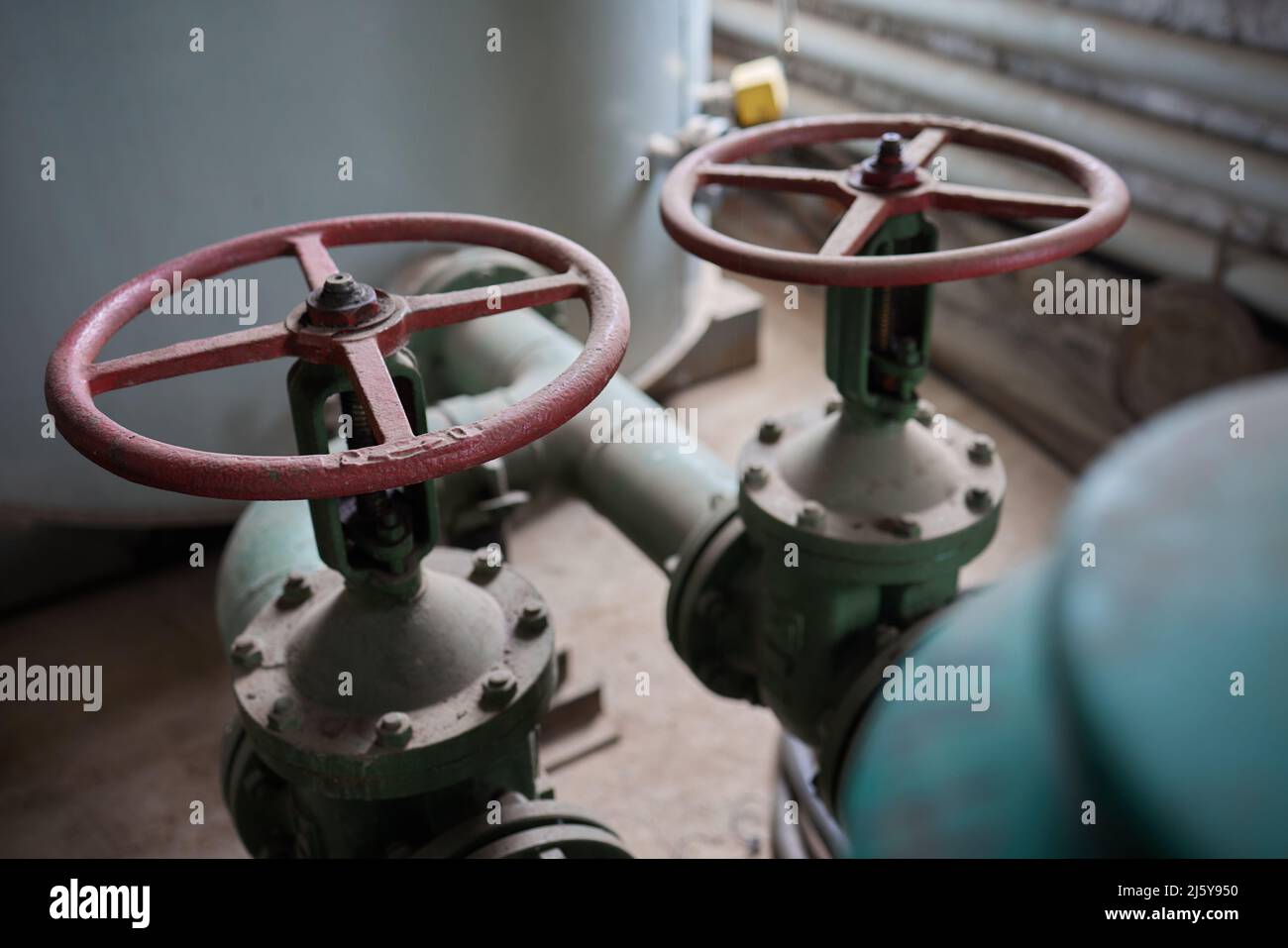 Close-up at pipeline valve which is using to control production process ...