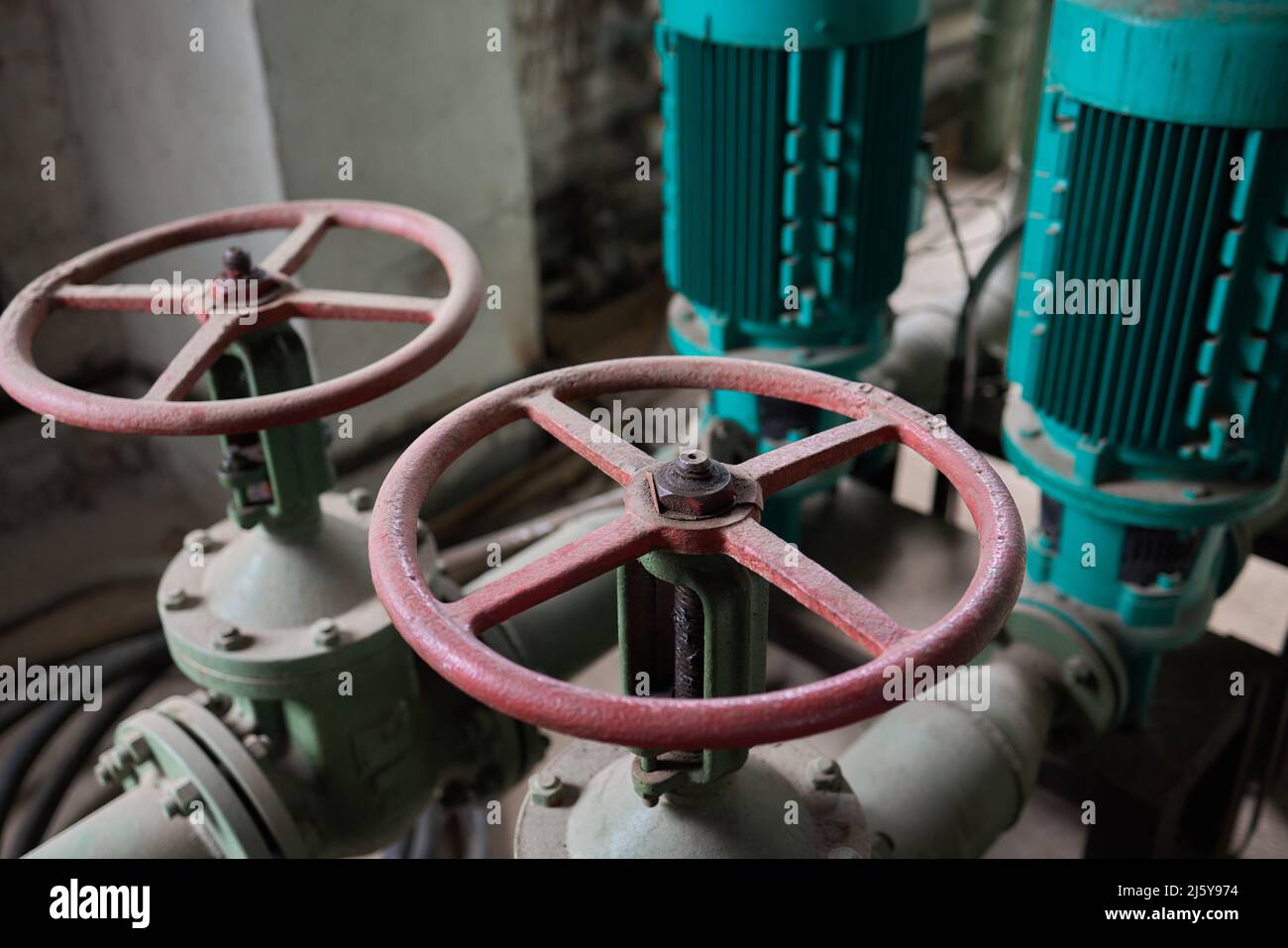 Close-up at pipeline valve which is using to control production process ...