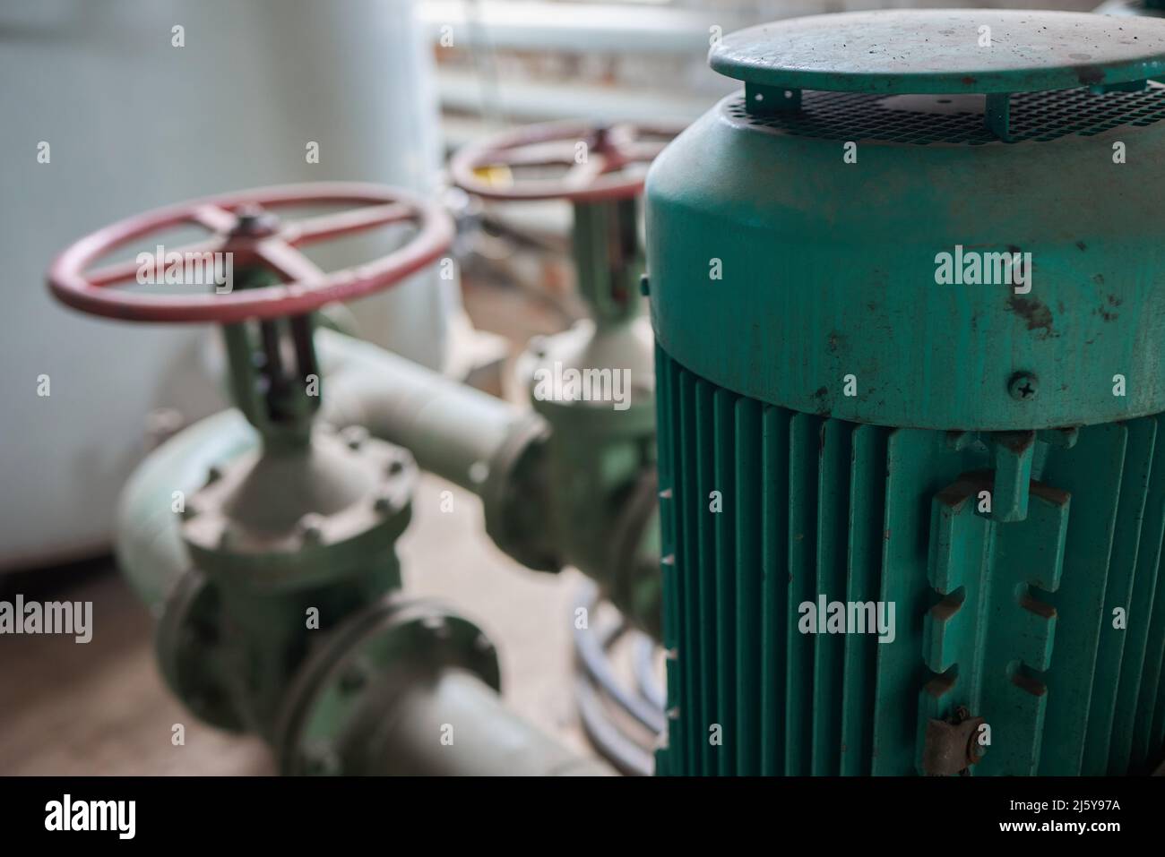 Close-up at pipeline valve which is using to control production process ...