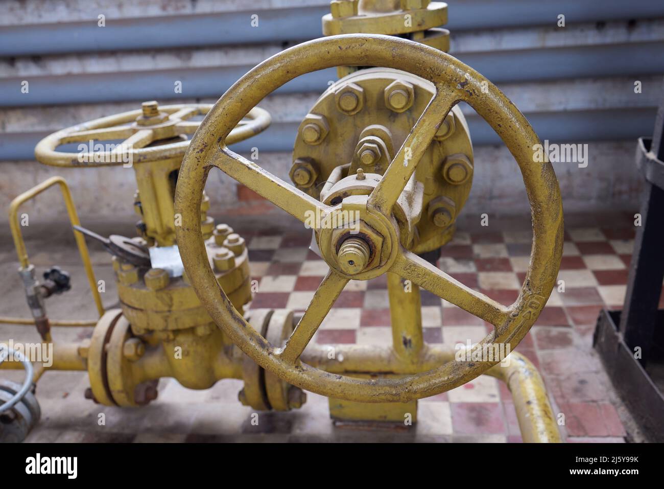 Close-up at pipeline valve which is using to control production process ...