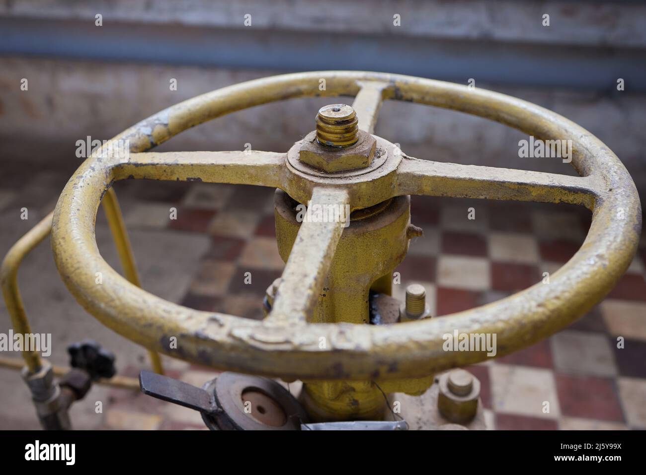 Close-up at pipeline valve which is using to control production process ...